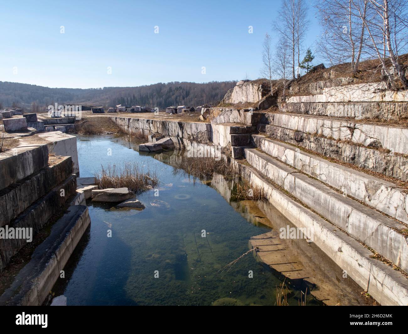 Autumn view of an abandoned quarry for the production of marble and ...