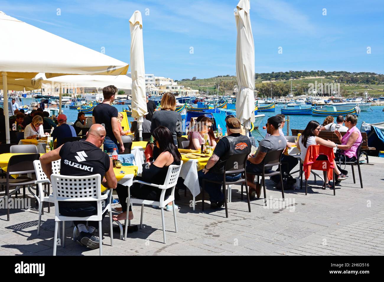 Tourists relaxing at a pavement cafes along the waterfront with ...