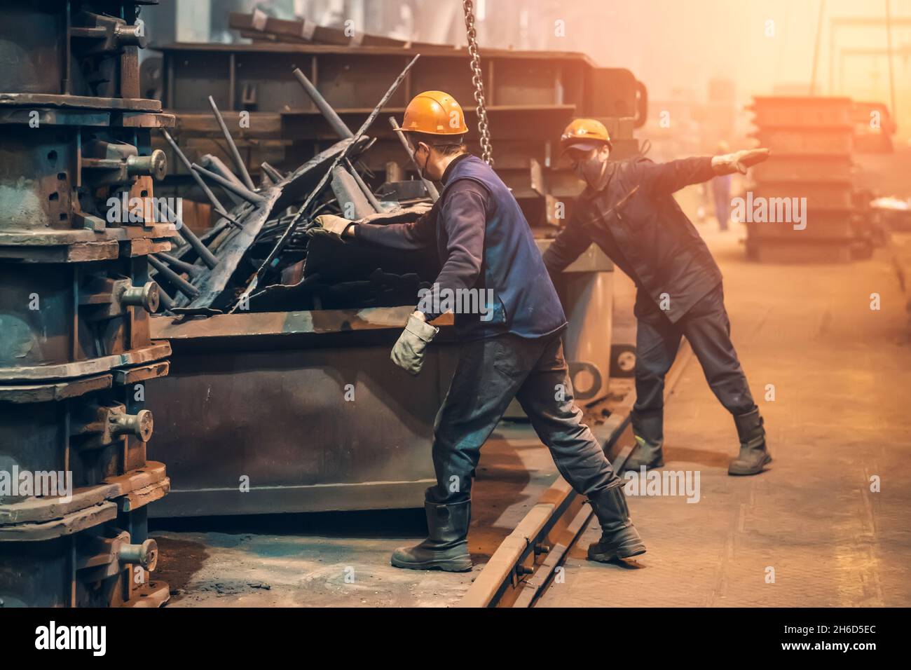 Metallurgical plant workers in process of work, industrial interior ...