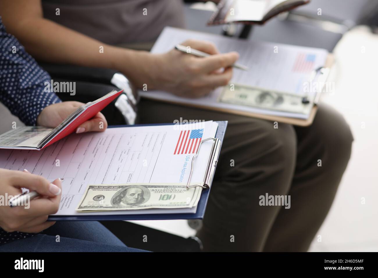Men sit in line and filling visa application forms to get access to ...