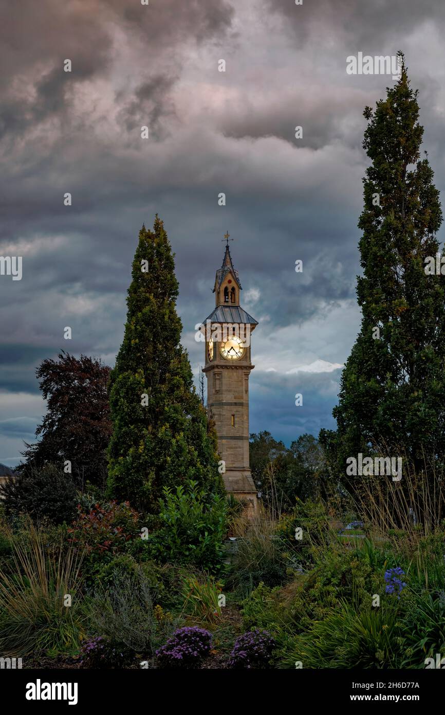 The iconic Albert Clock tower with illuminated clock face at dusk, a ...