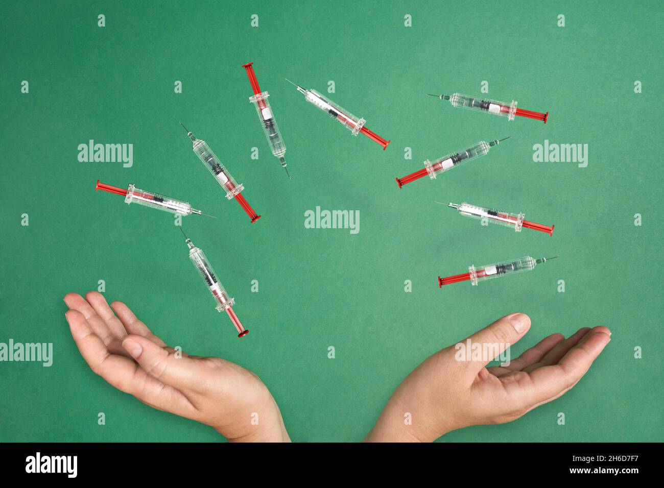 Hand holding injectors on green background. Concept art photography ...