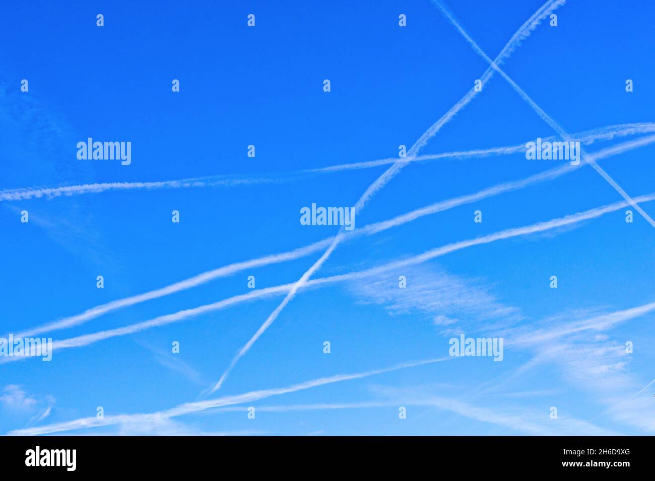 Contrails patterns of high flying aircraft against a deep blue sky over ...