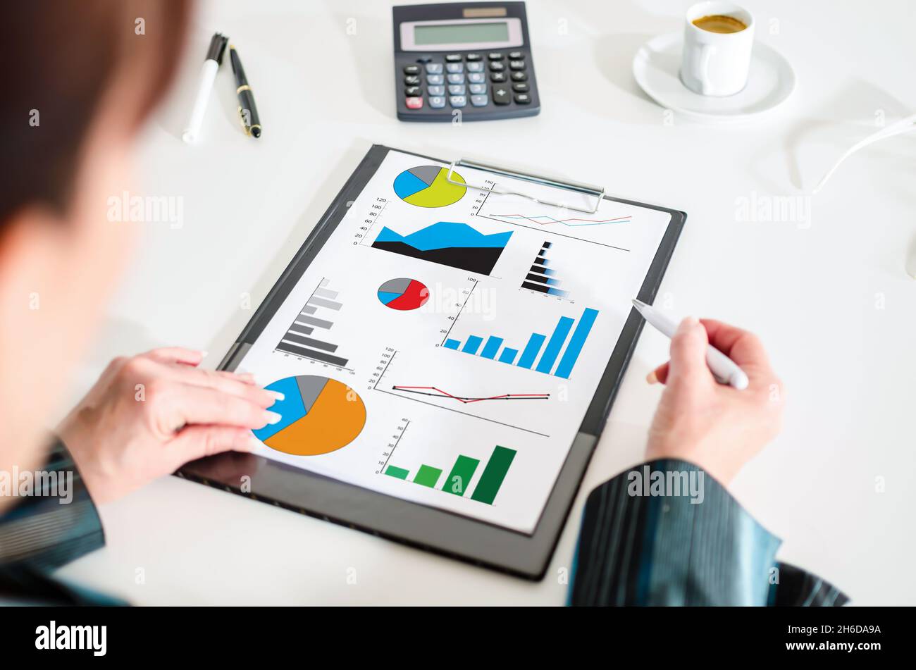 Woman looking at a graphical analysis concept Stock Photo - Alamy