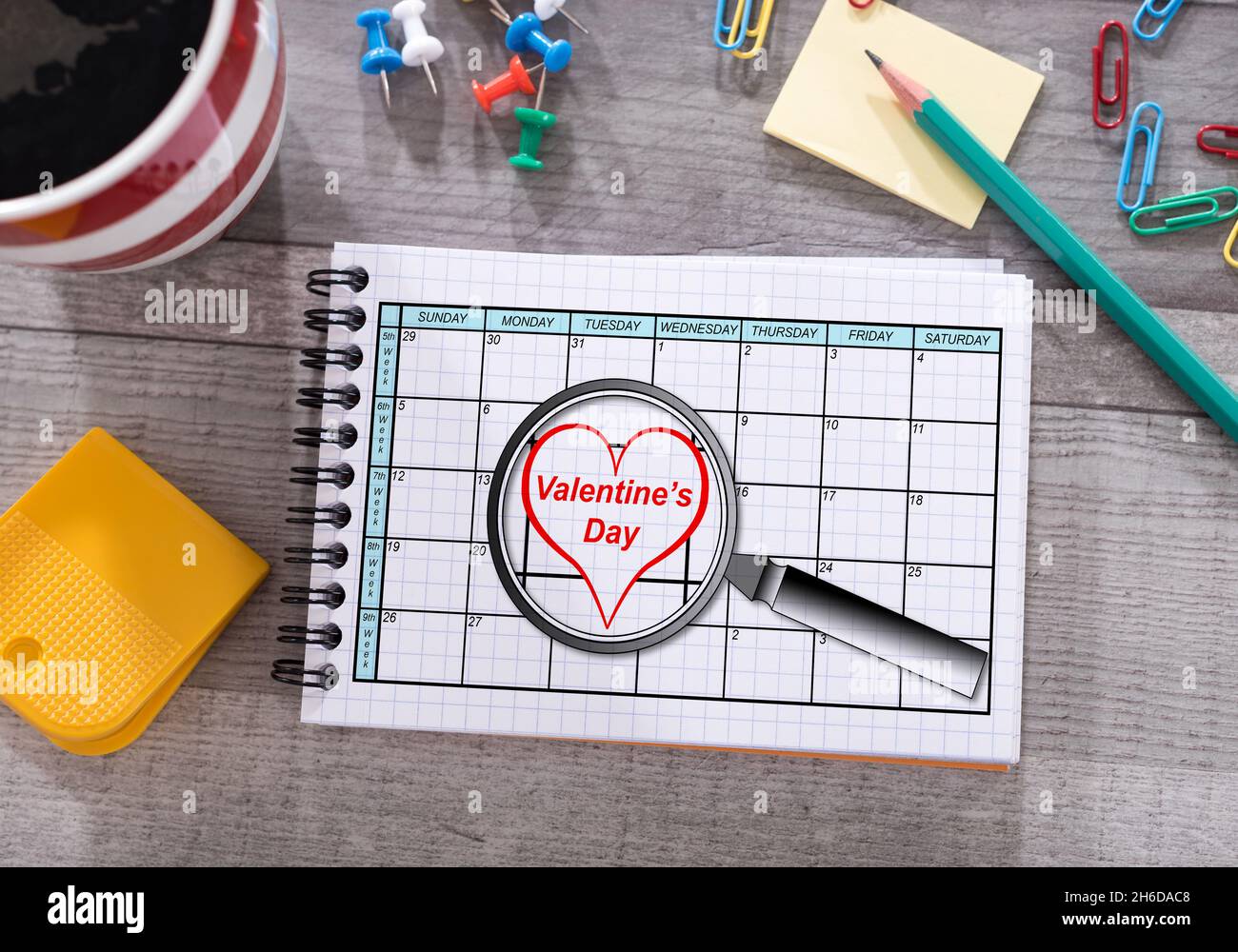 Valentines day on planner enlarged by a magnifying glass Stock Photo ...