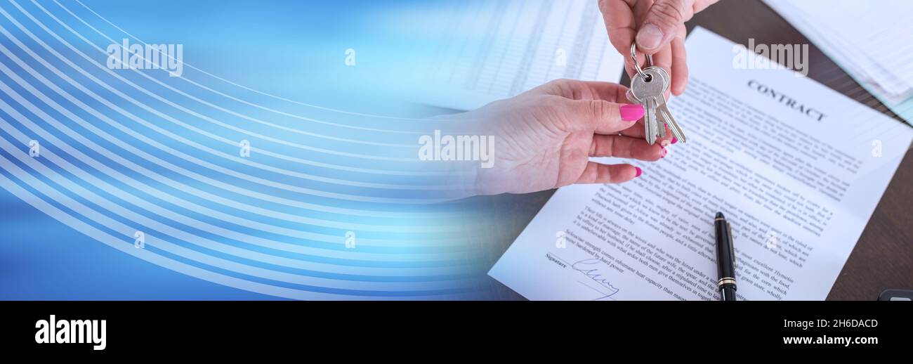 Realtor giving house keys to his client after signing the contract ...