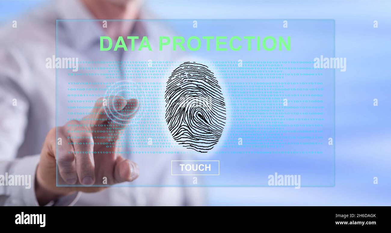 Man touching a data protection concept on a touch screen with his ...