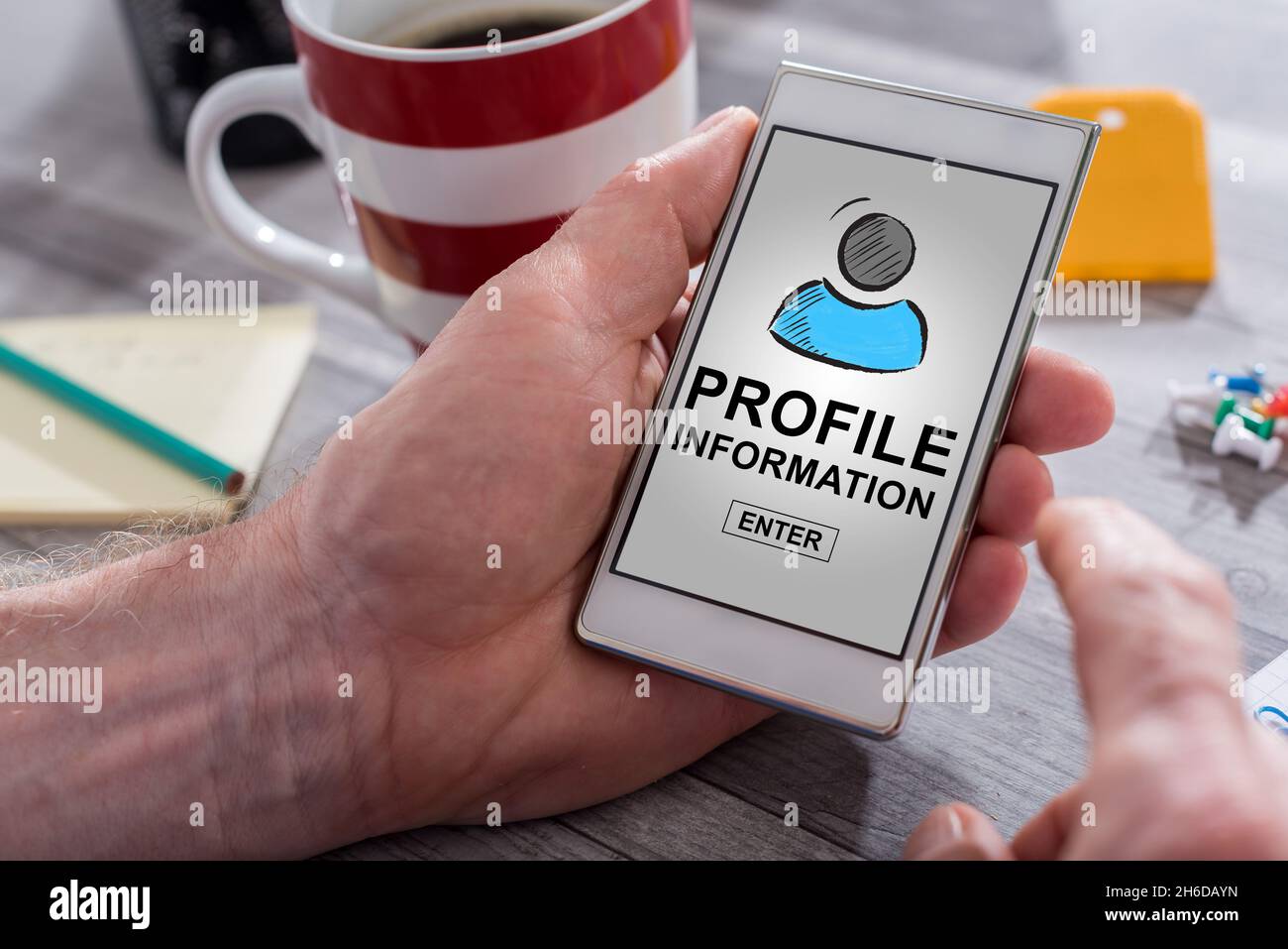 Male hand holding a smartphone with profile information concept Stock ...