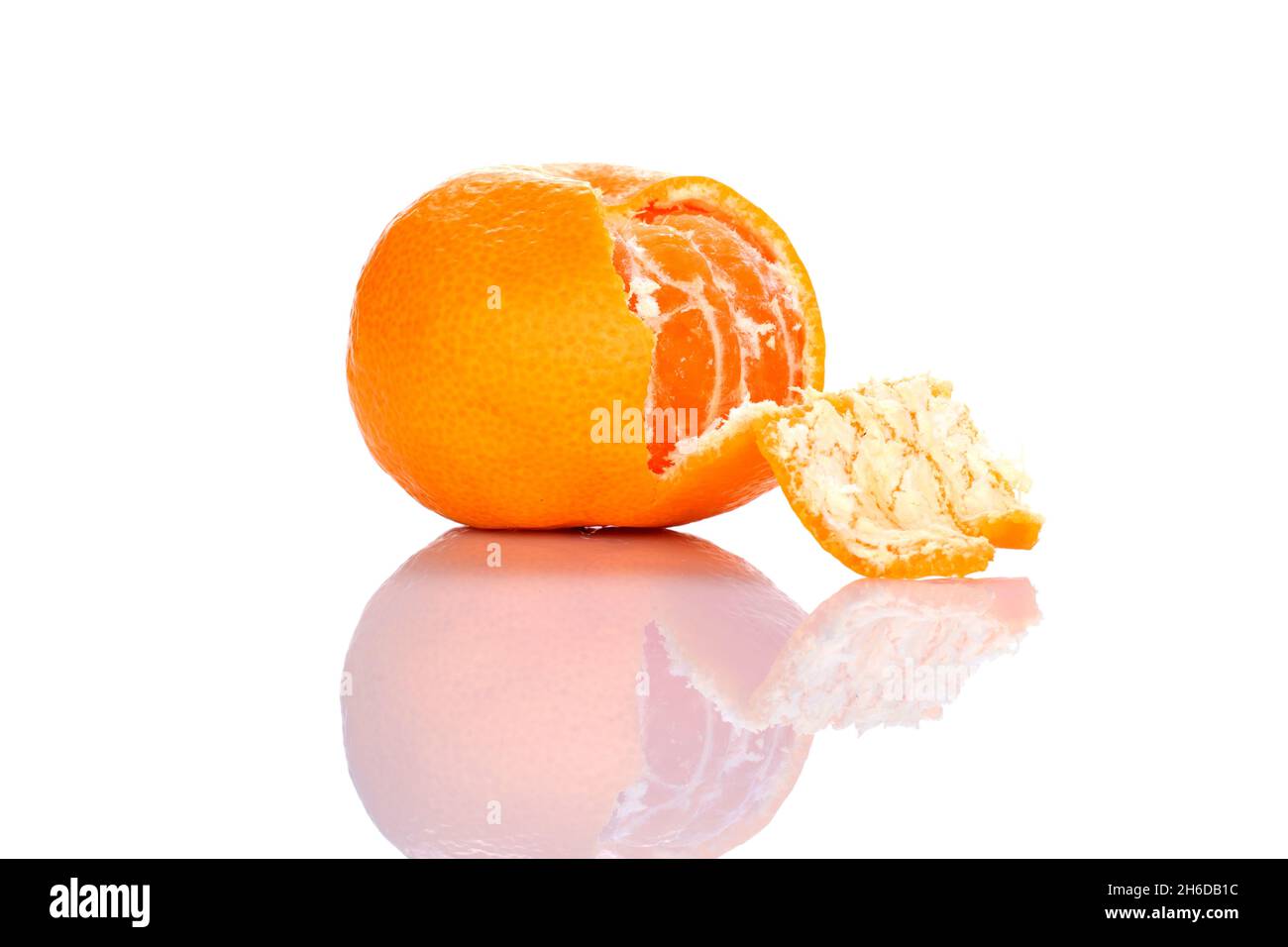 One whole bright orange sweet and sour tangerine, on one side the peel ...