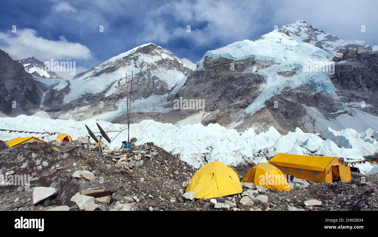 view from Everest base camp to west rock face of Nuptse peak with tents ...