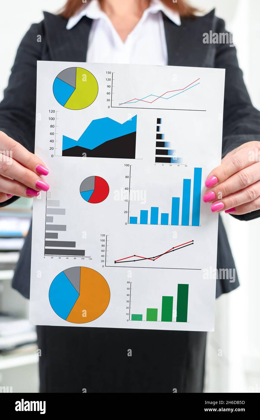 Paper with graphical analysis concept held by a businesswoman Stock ...