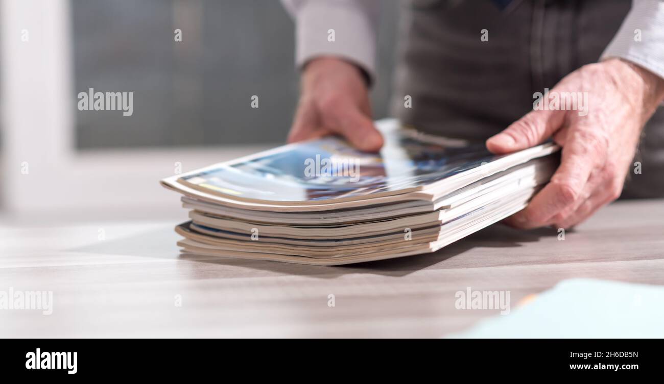 Pile of magazines with hands hi-res stock photography and images - Alamy