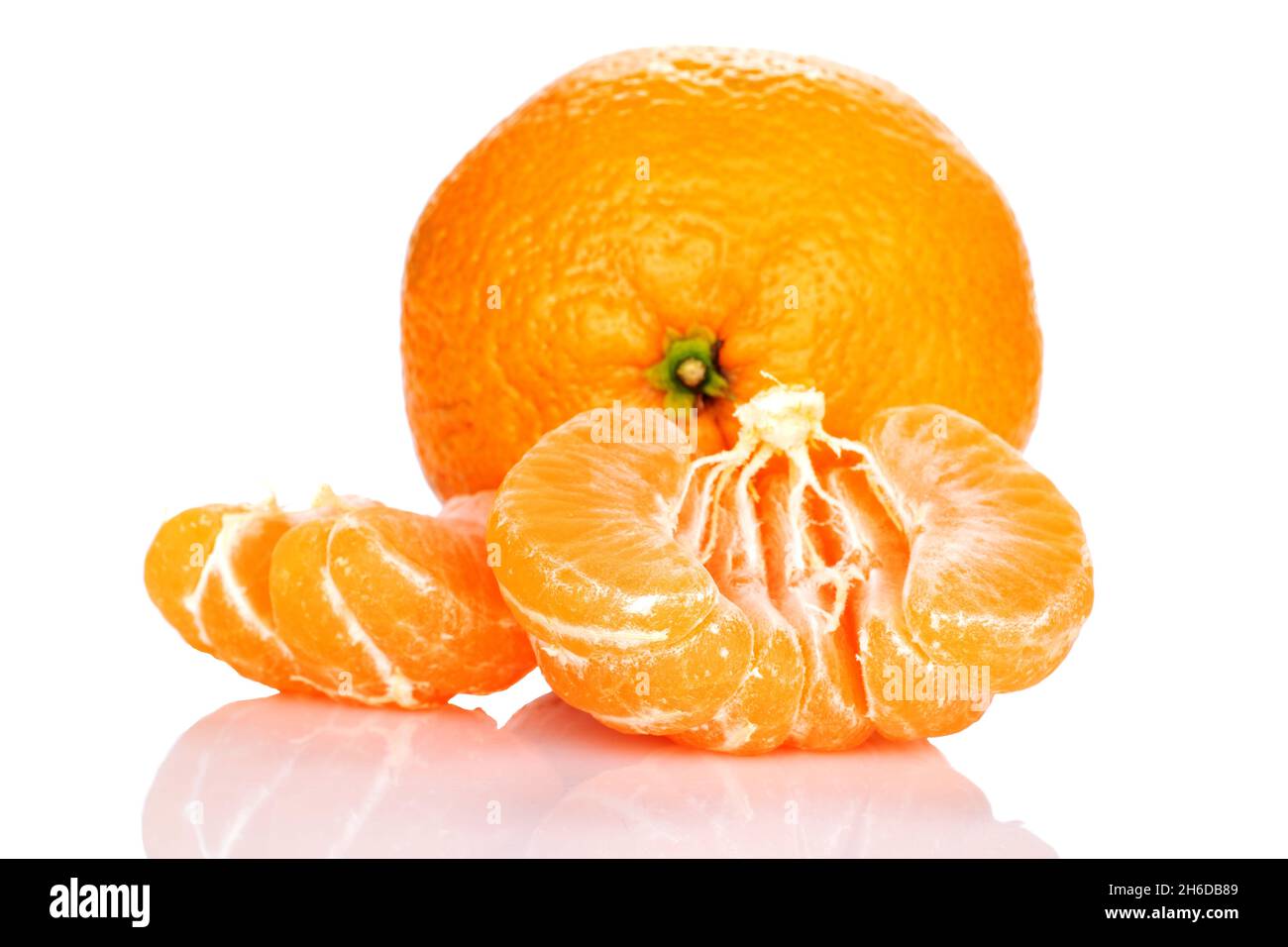 One peeled mandarin and one unpeeled, close-up, isolated on white Stock ...