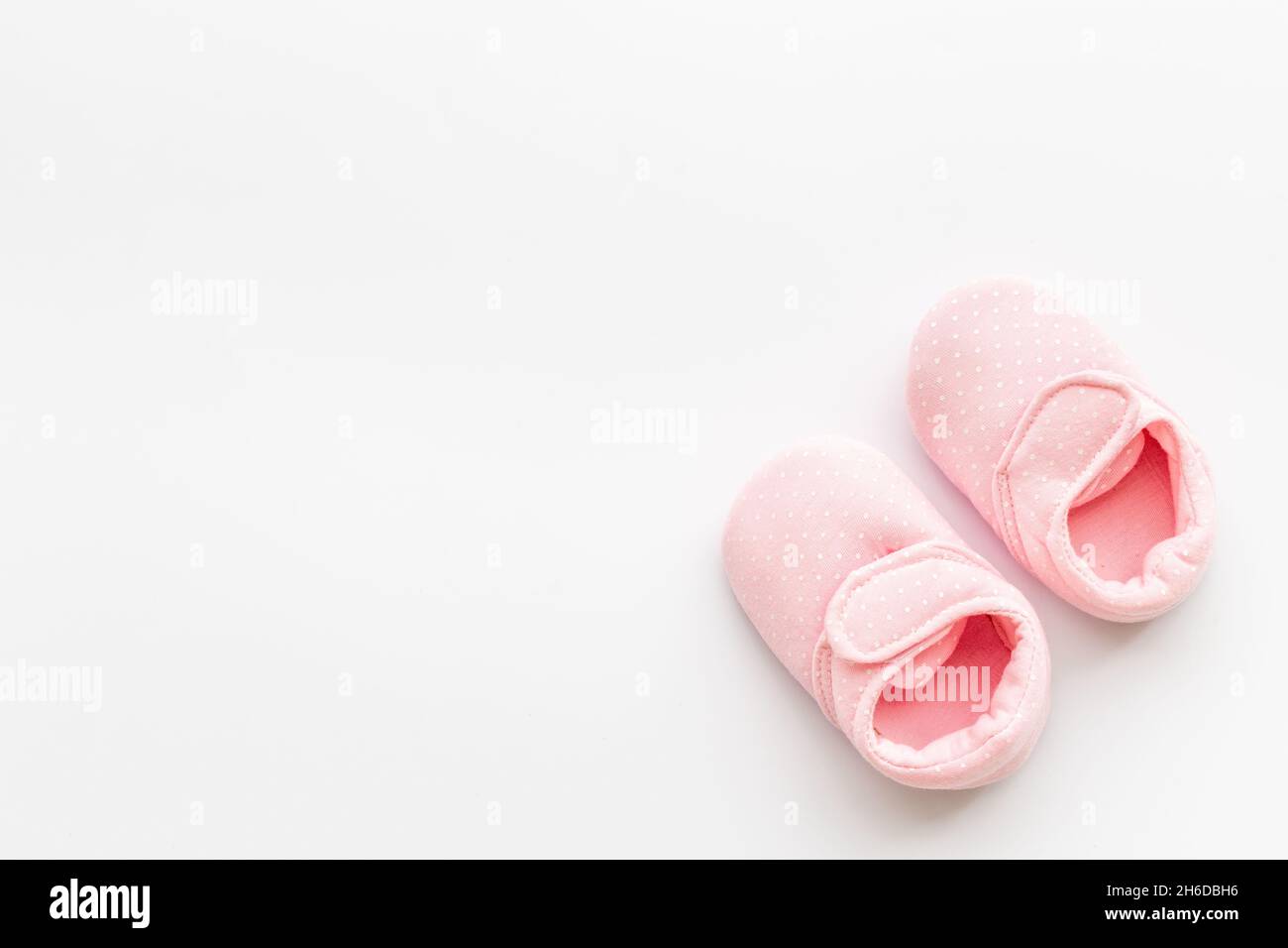 Baby girl pink newborn booties - child birth background Stock Photo - Alamy