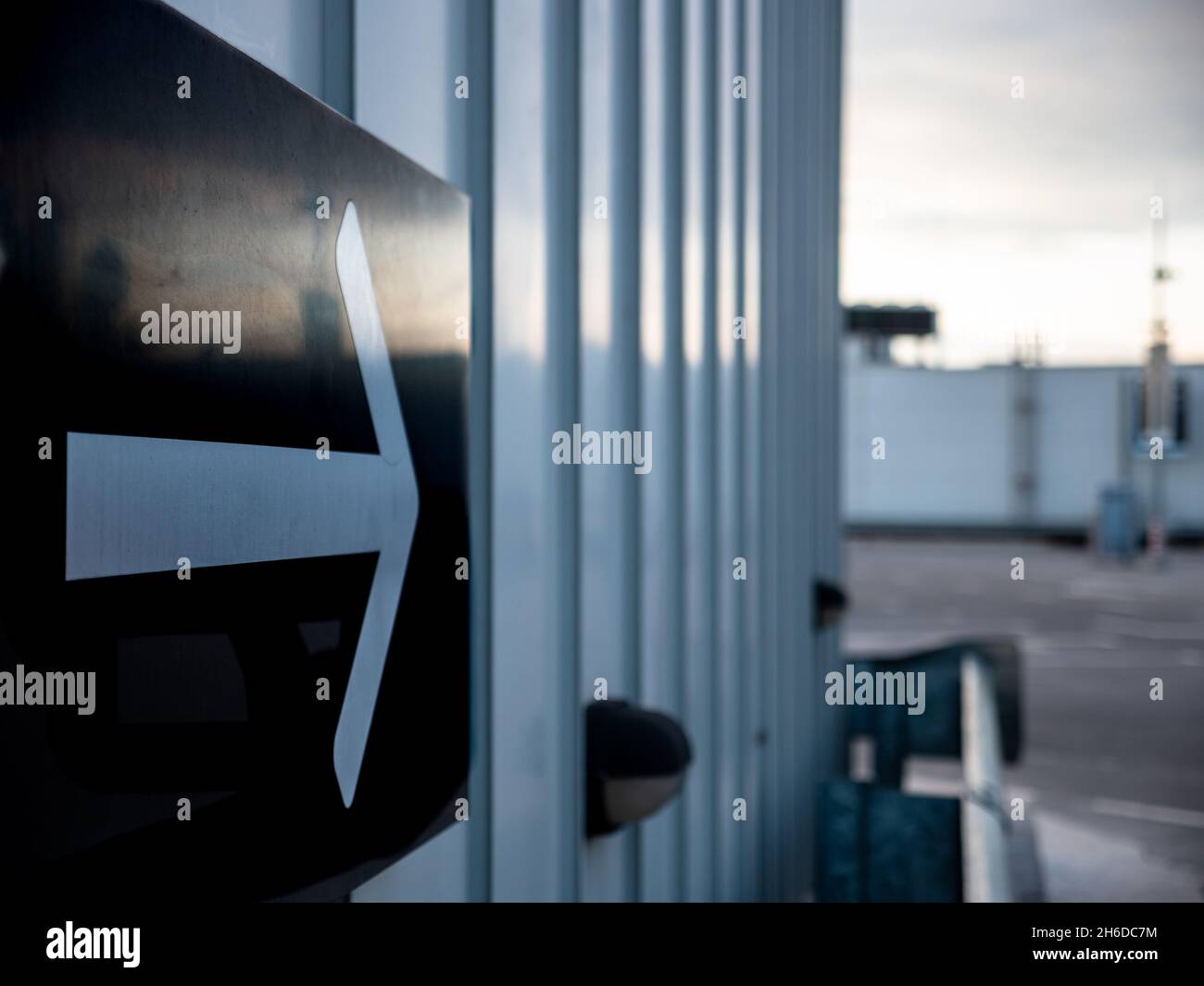 Directional exit right arrow sign in black and white on the metal wall ...