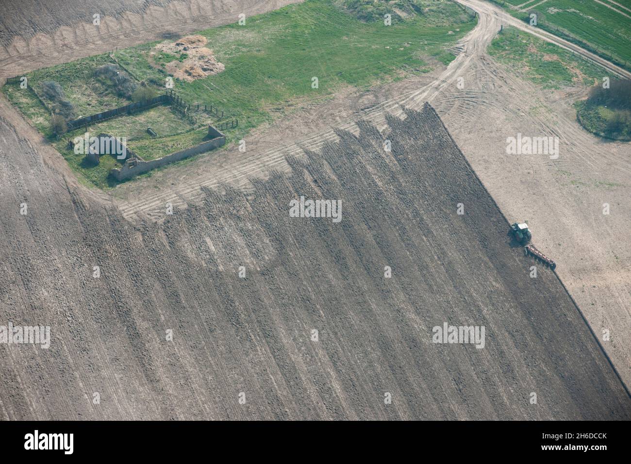 A round barrow showing as a soilmark in a freshly ploughed field near ...