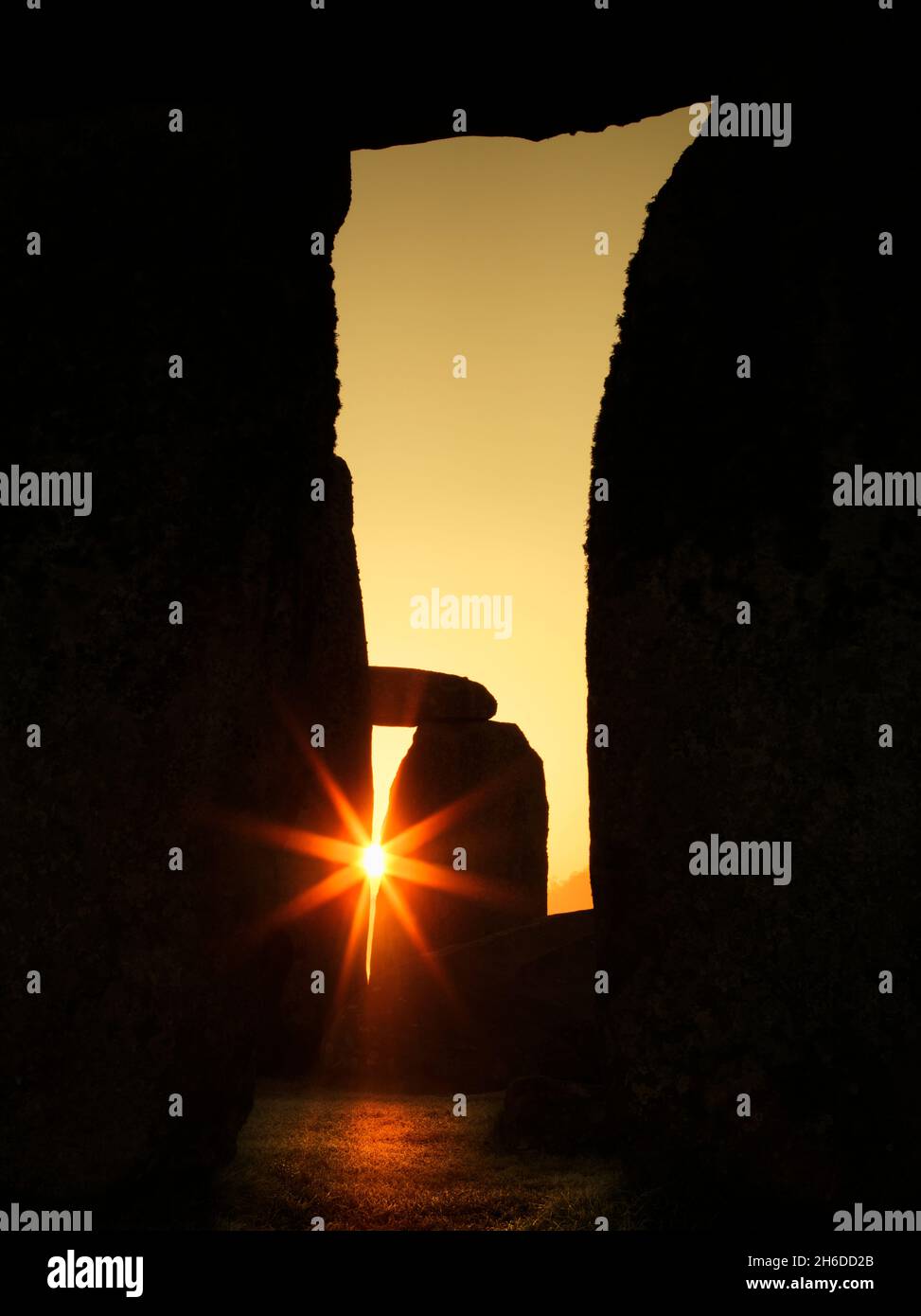 General view of Stonehenge, showing the rays of the rising sun shining ...