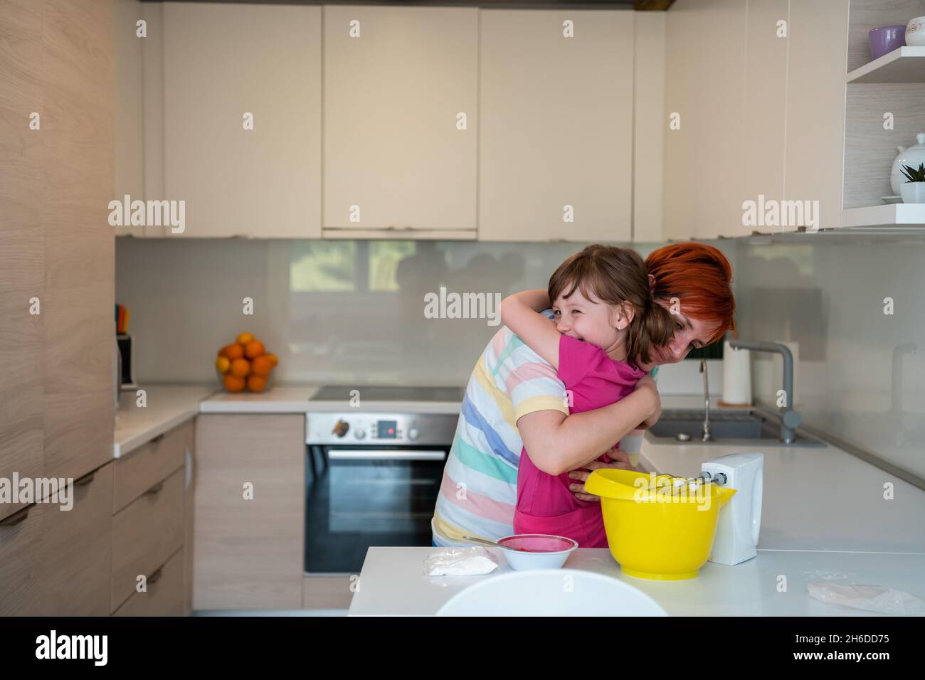 Funny little girl helper playing with dough on his hands learning to ...