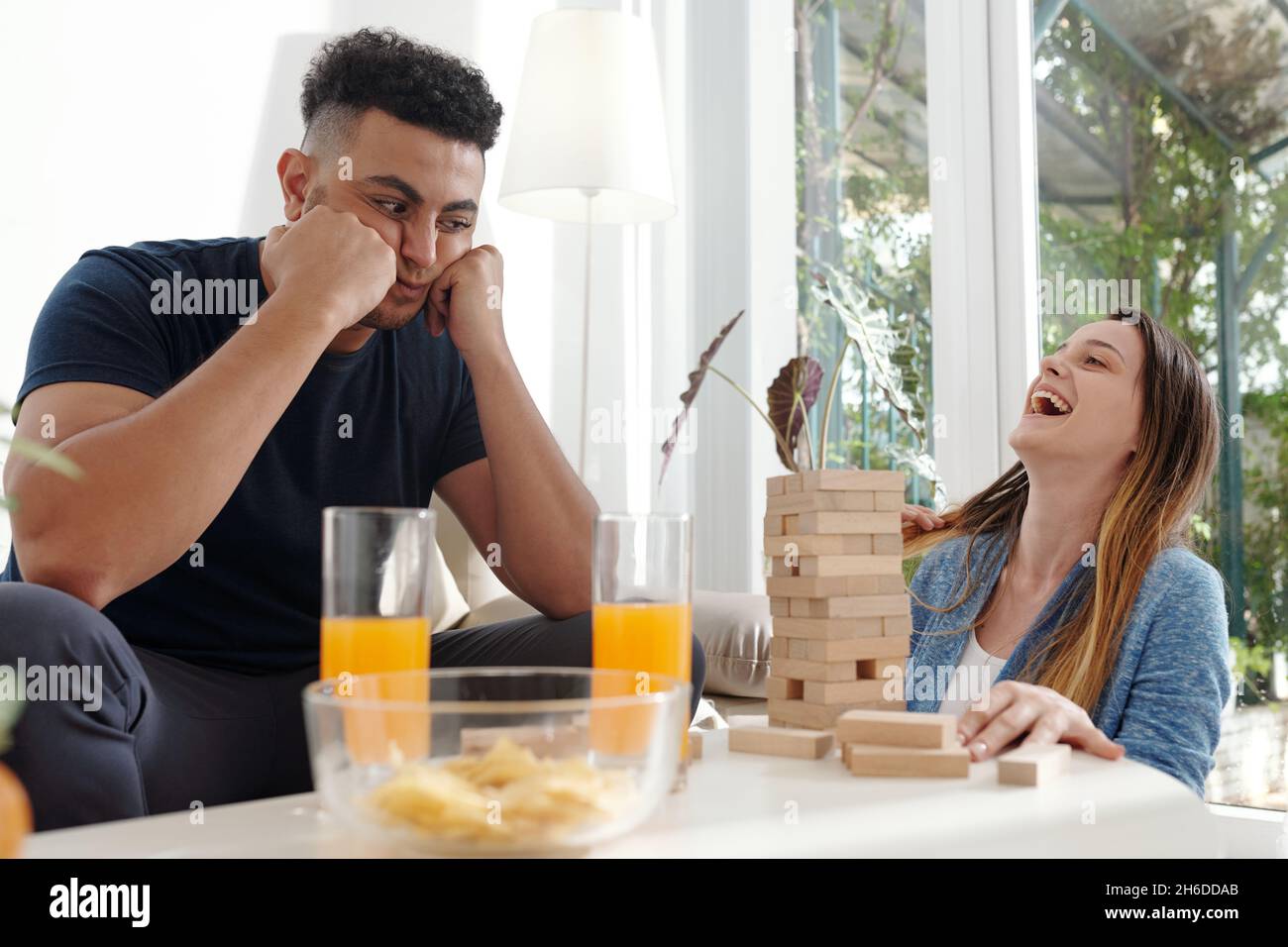 Pretty young woman laughing celebrating victory in board game when ...