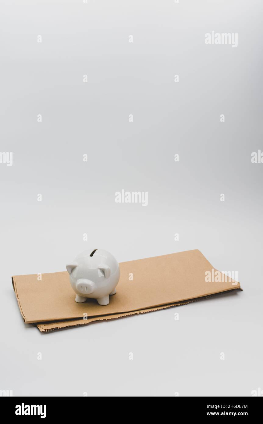 white still bank on a folded brown paper bag on a white background ...