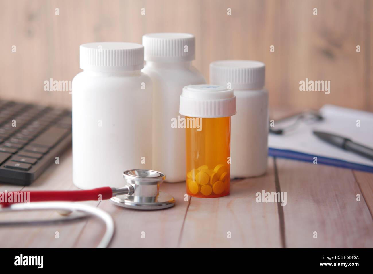 doctors workplace with container, keyboard and prescription on desk ...