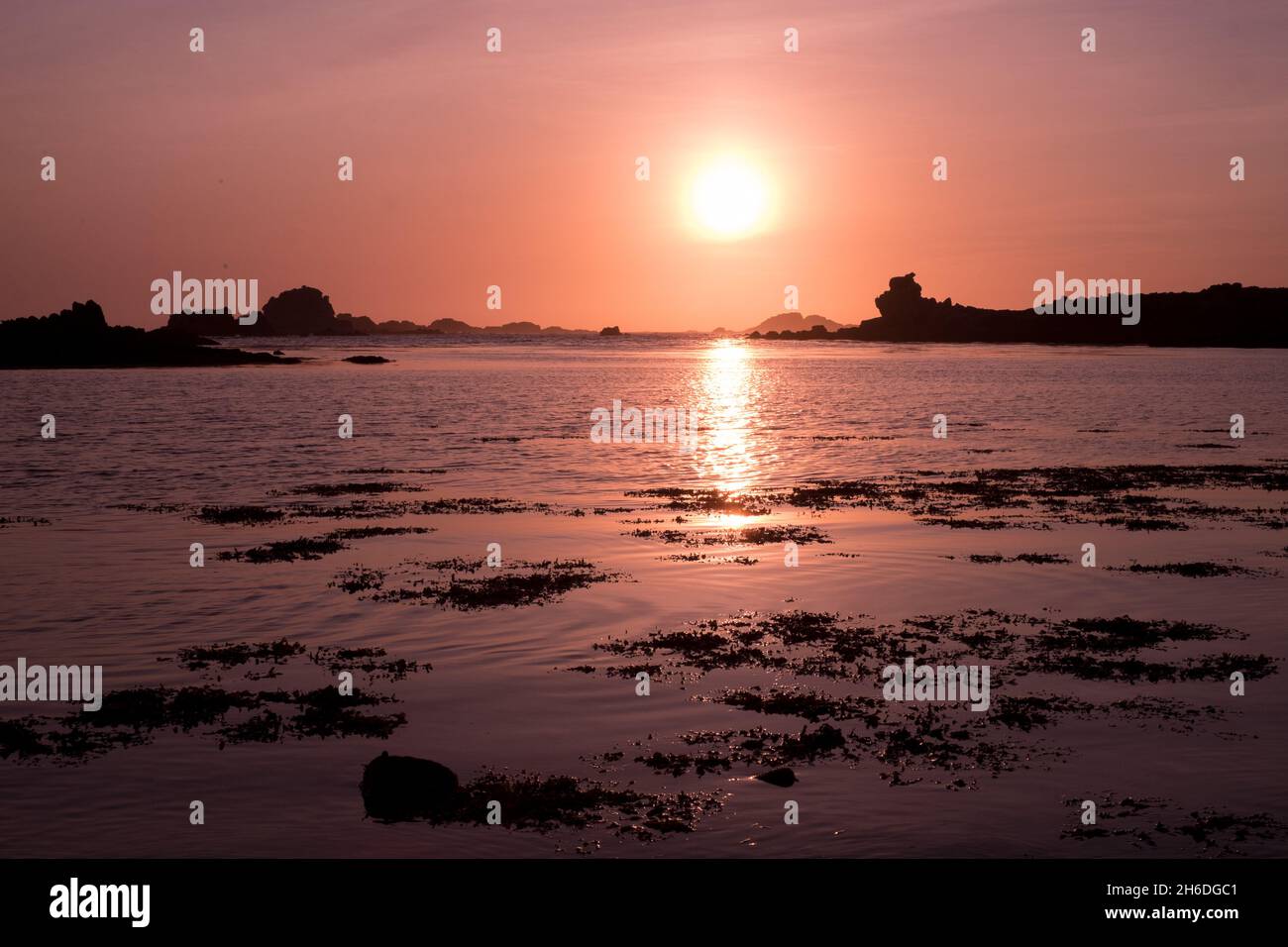 Sun setting over the rocks off Bryher, Isles of Scilly, viewed from ...