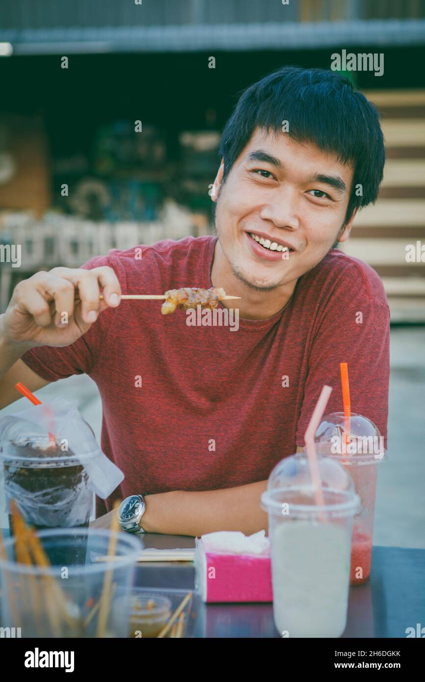 Man eating meat stick hi-res stock photography and images - Alamy