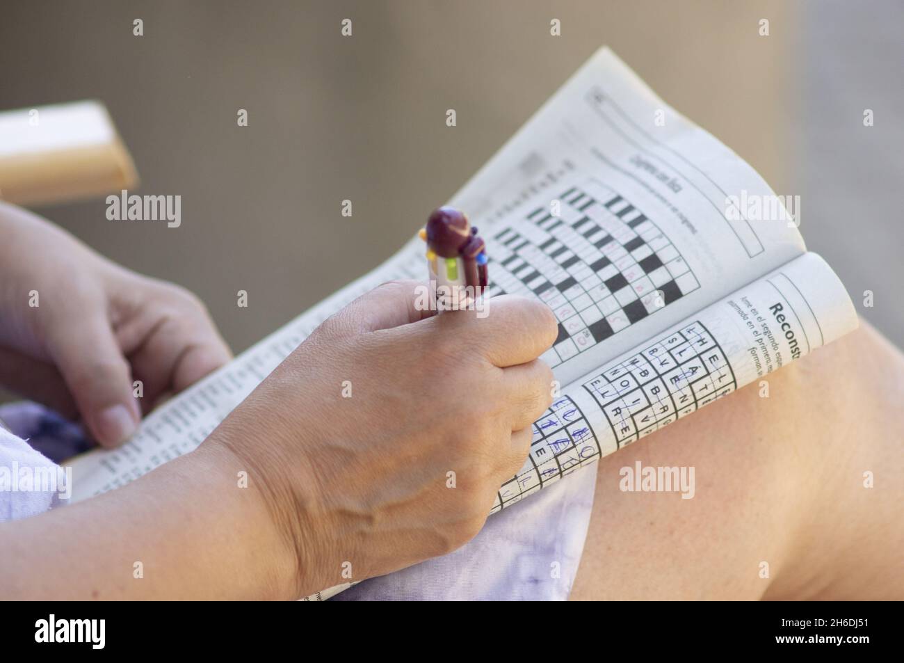 Completing crossword puzzle hi-res stock photography and images - Alamy