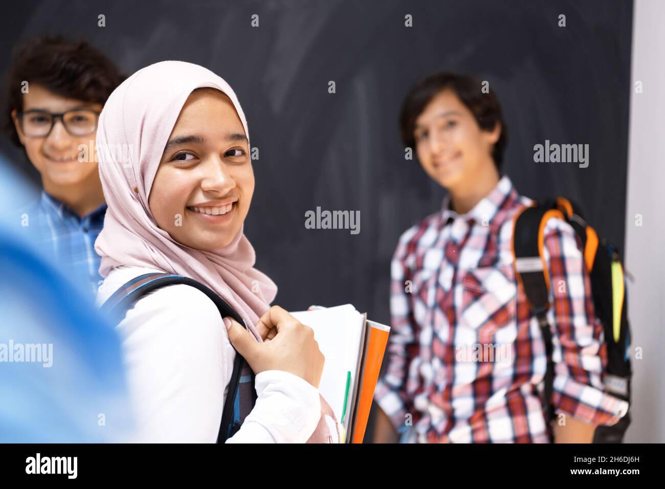 Arabic teenagers, students group portrait against black chalkboard ...
