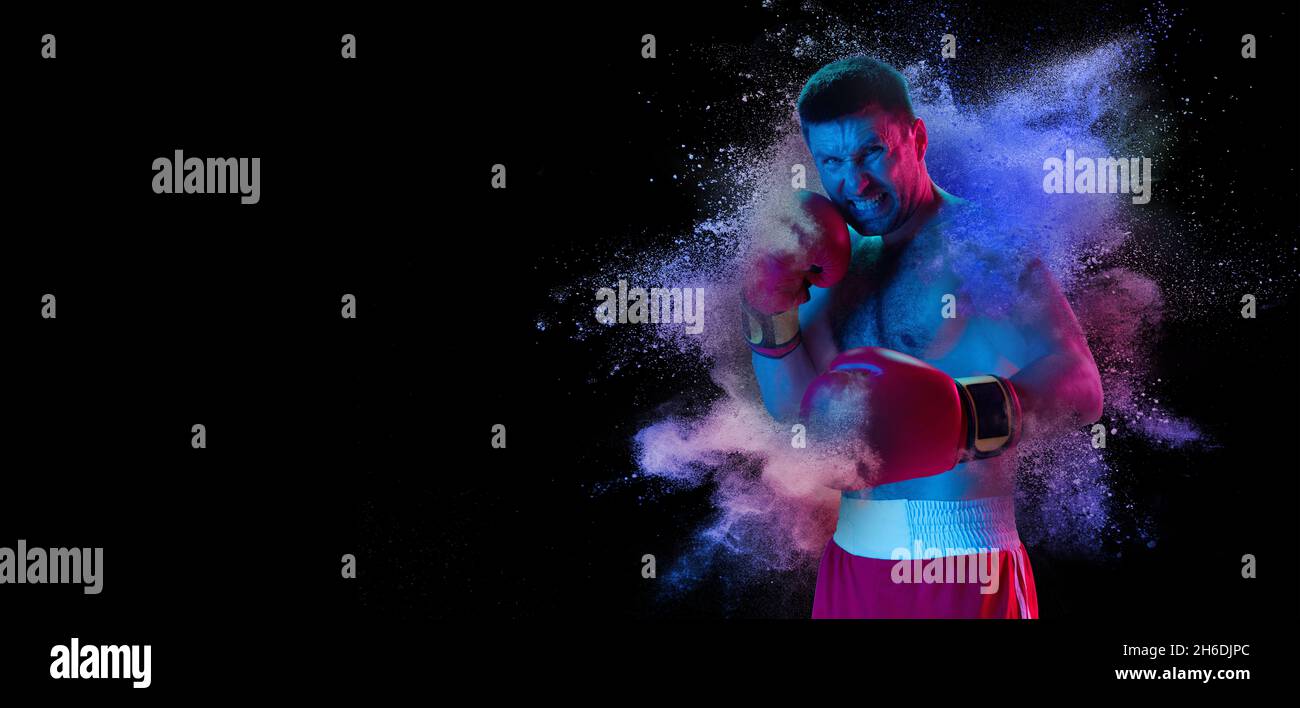 Bright artwork. Professional male boxer in motion in explosion of ...