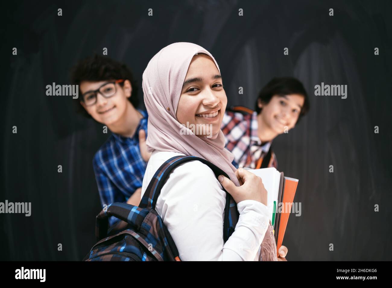 Arabic teenagers, students group portrait against black chalkboard ...