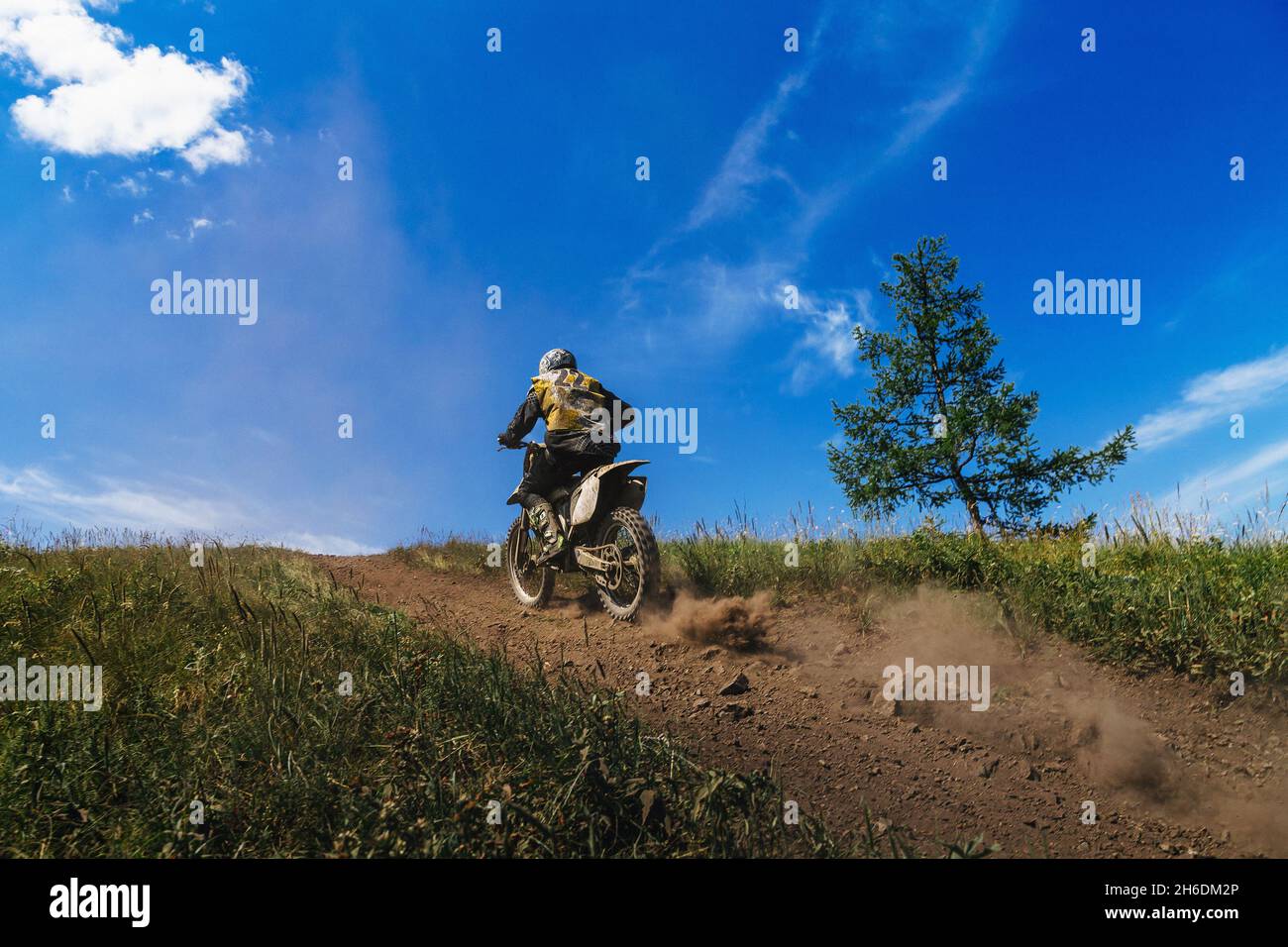 back male biker in enduro motorcycle riding on mountain trail Stock ...