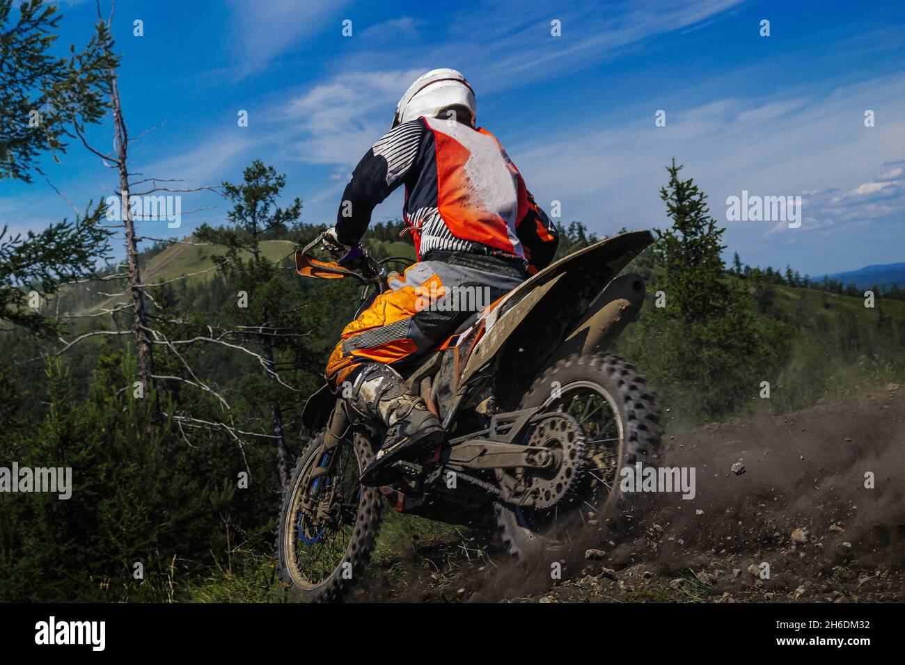 enduro motorcycle racer riding on mountain trail Stock Photo - Alamy