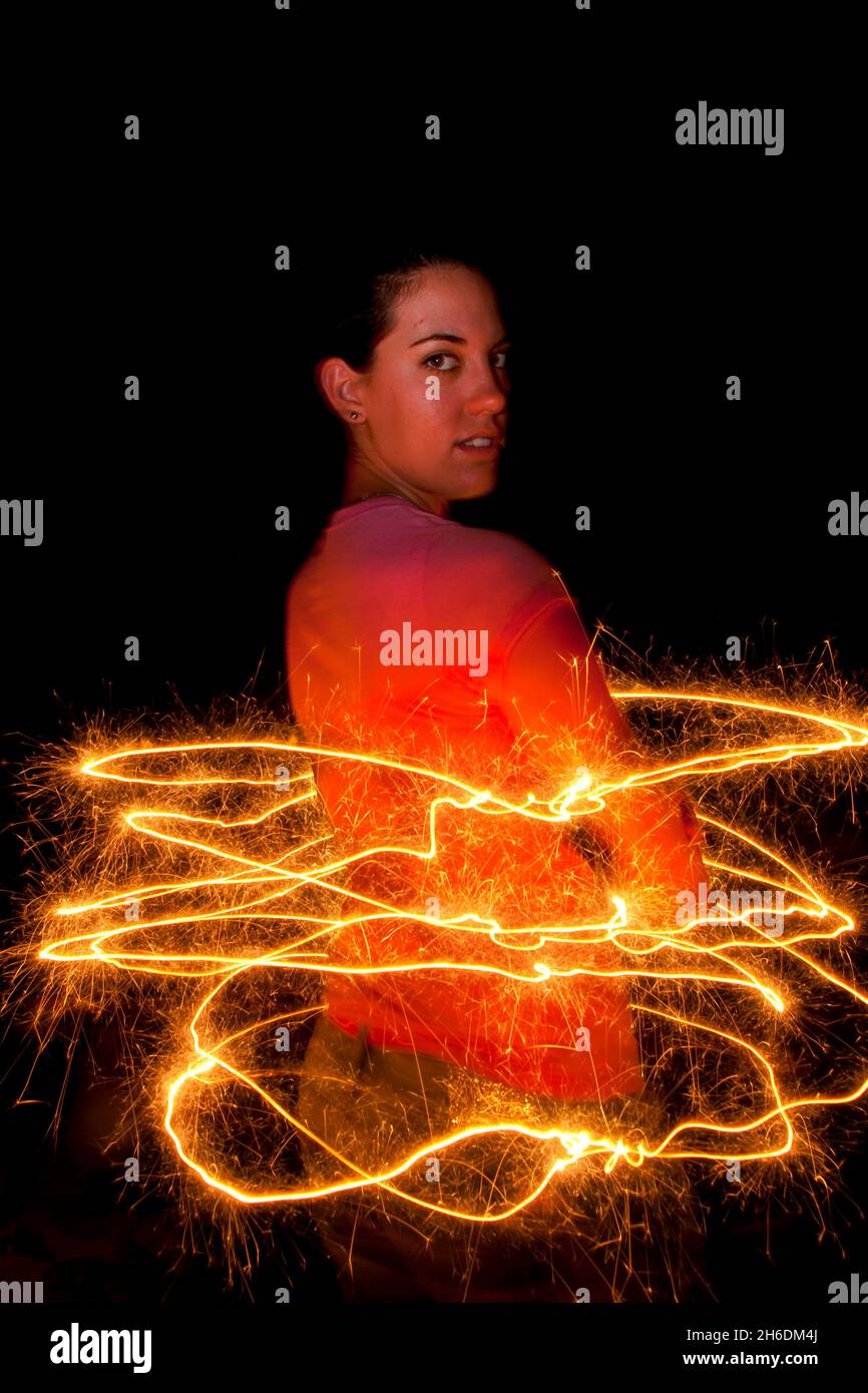 Woman engulfed in streaks of burning light Stock Photo - Alamy