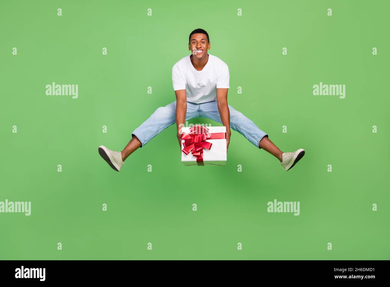 Full length photo of young african guy present party celebrate jumper ...