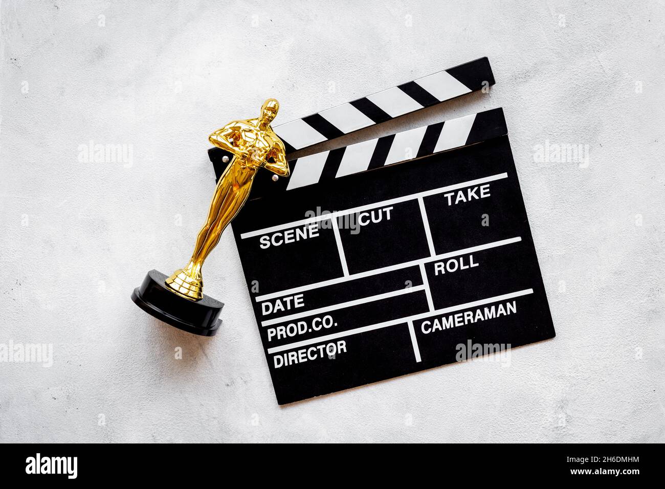 Golden movie award statue with cinema clapper board Stock Photo - Alamy