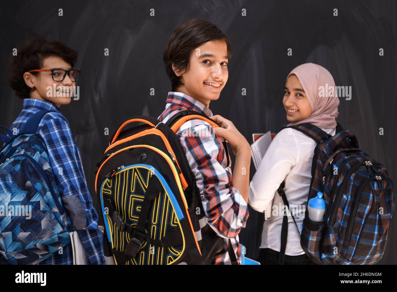 Arabic teenagers, students group portrait against black chalkboard ...