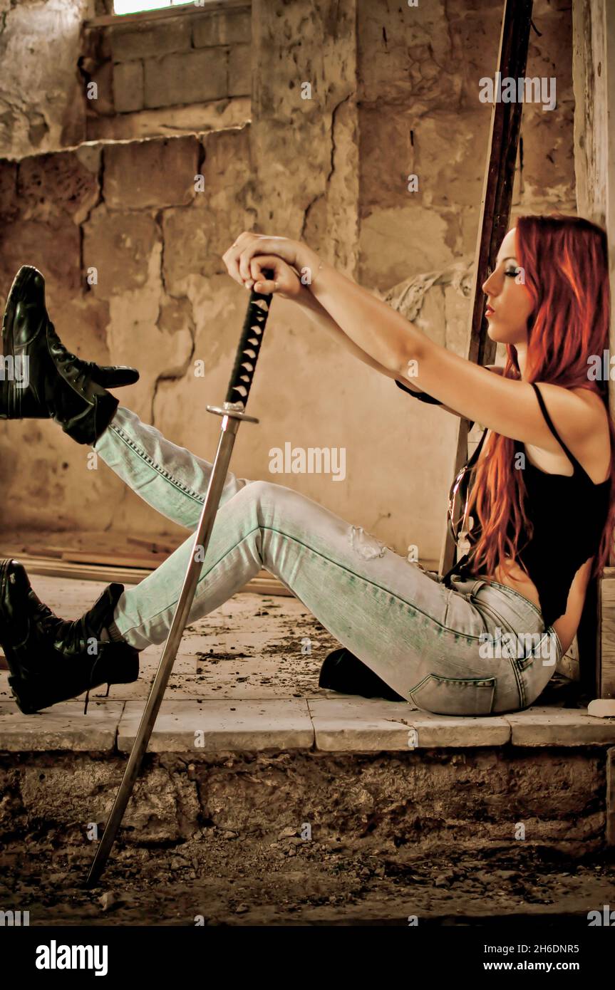 Aggressive Young woman of 24 with a Samurai Sword Stock Photo - Alamy