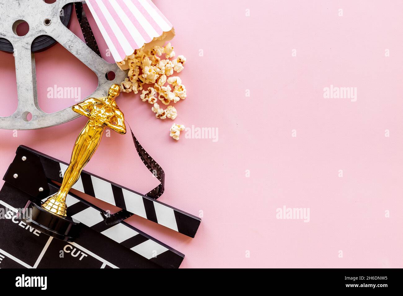 Golden movie award statue with film reel video tape and clapper board ...