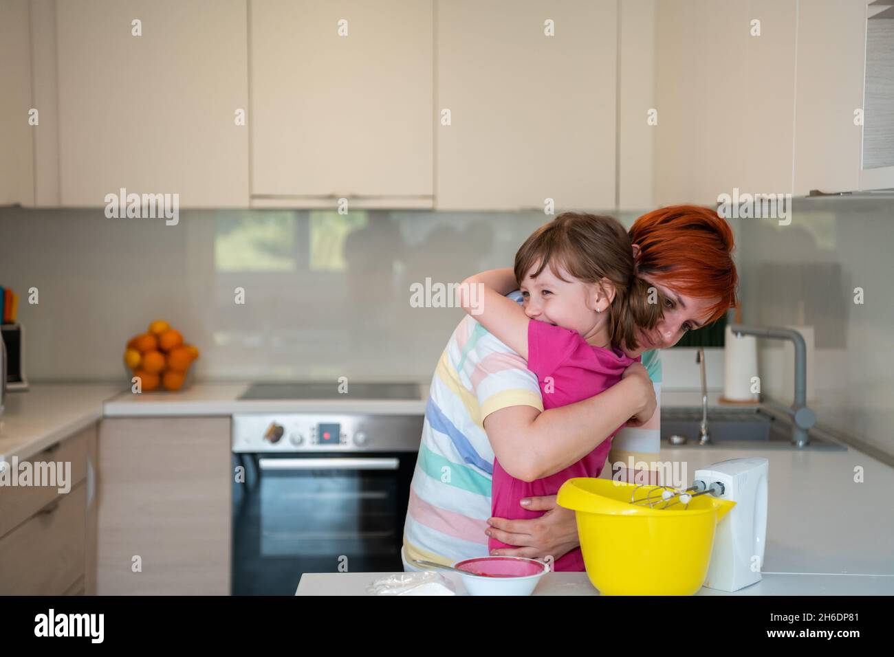 Funny little girl helper playing with dough on his hands learning to ...