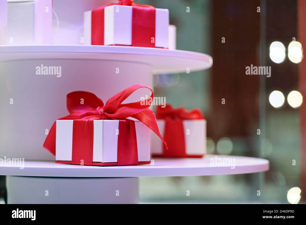 Gift boxes in window store on blurred lights background. Concept of ...