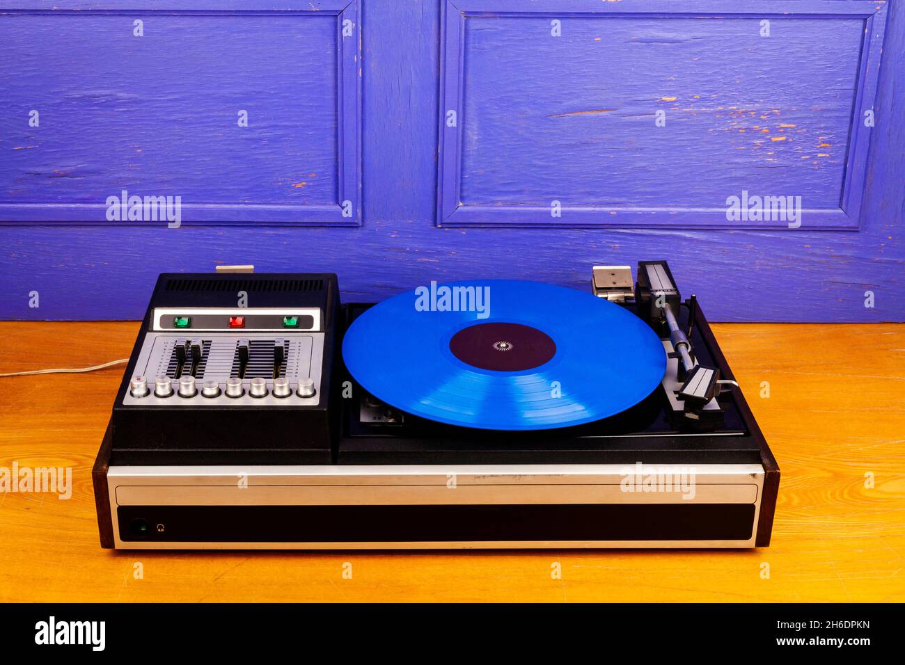 Vintage turntable vinyl record player with blue vinyl on a table Stock ...