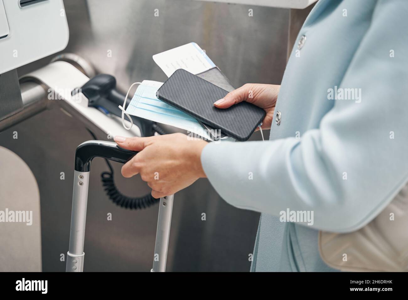 Passenger with baggage and travel documents at airport terminal Stock ...