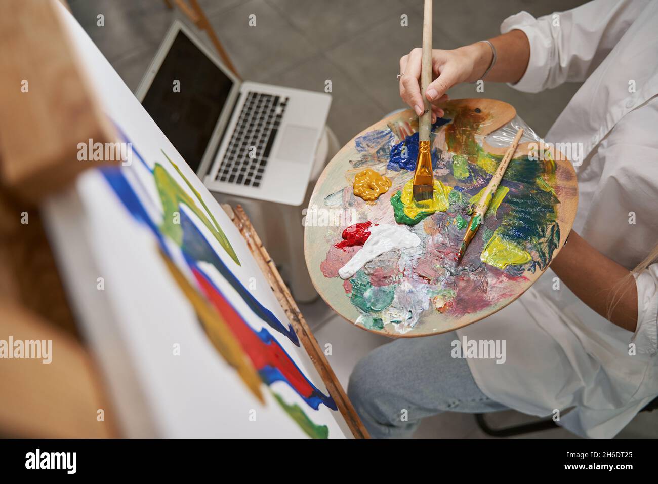 Low angle picture of painter mixing colors Stock Photo - Alamy