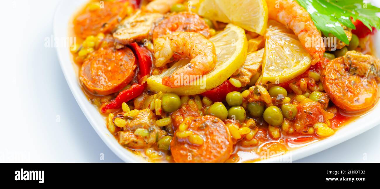 Delicious paella, cooked risotto rice with chicken thigh, king prawns ...