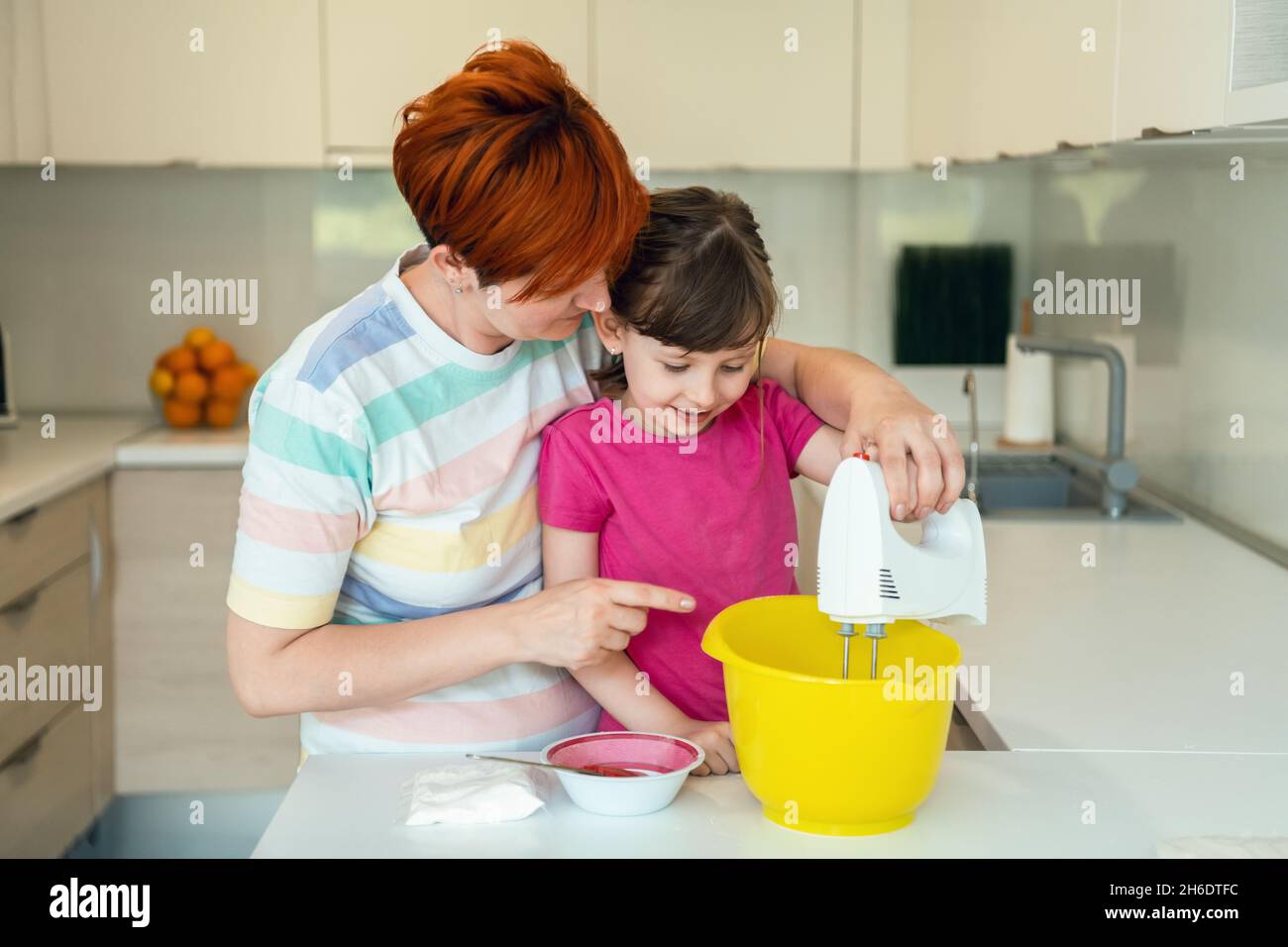 Funny little girl helper playing with dough on his hands learning to ...
