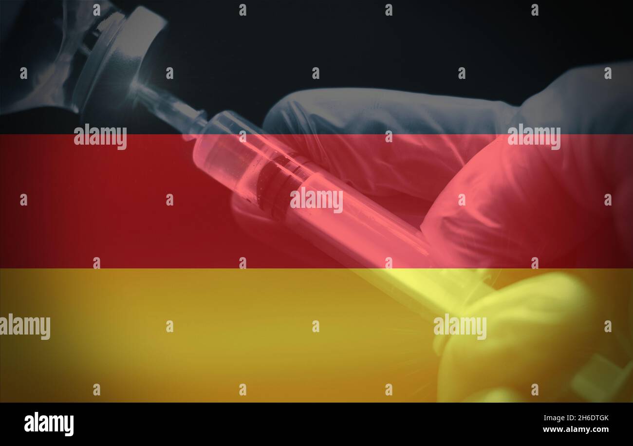 Syringe with the German flag as background, concept of 3rd dose of ...