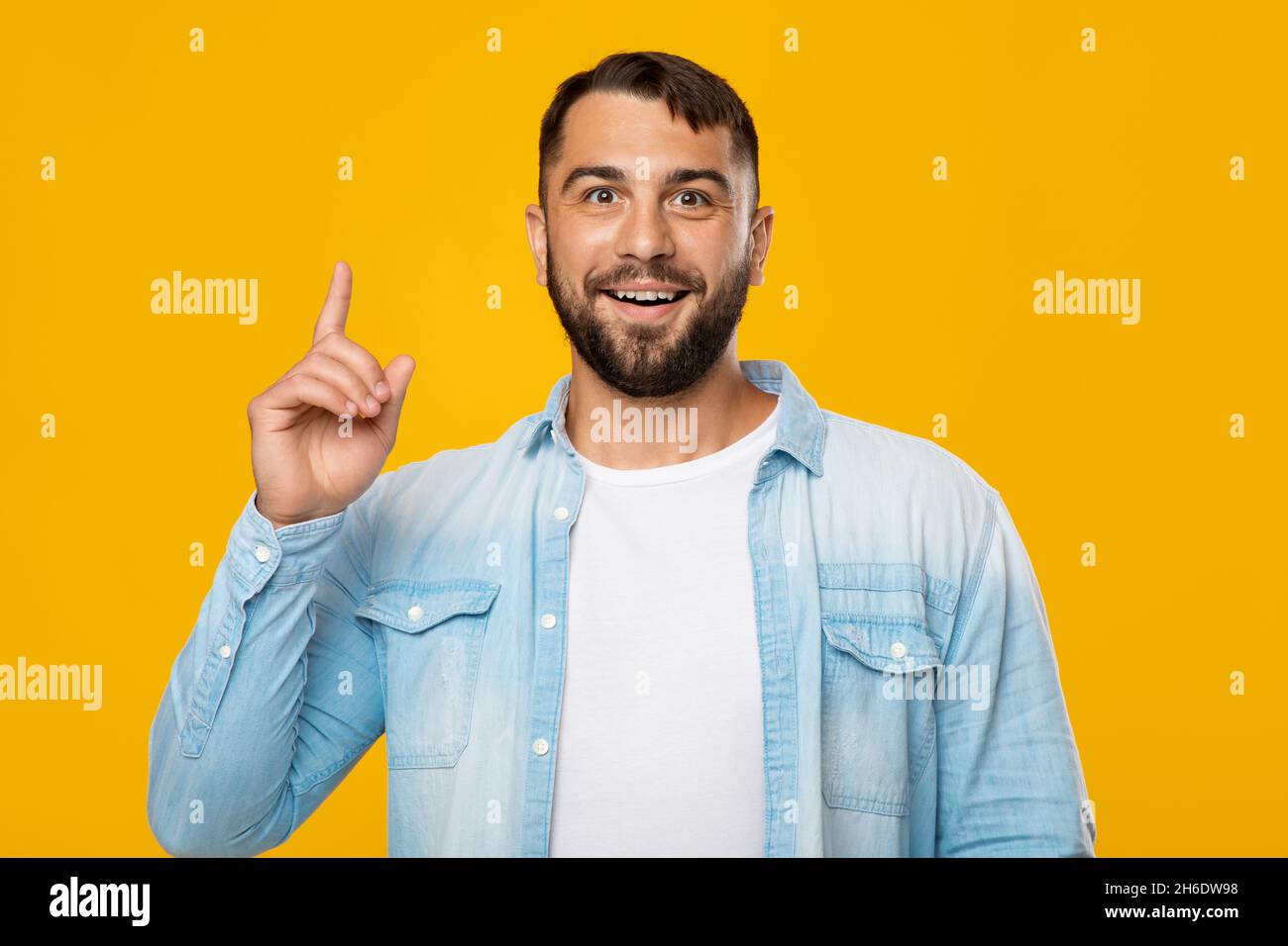 Smiling inspired smart middle aged european man with beard raises ...