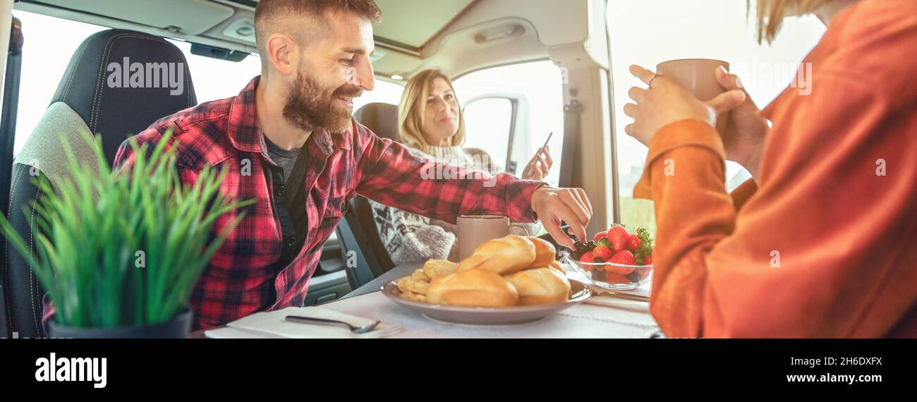 Friends having breakfast in a camper van in the morning Stock Photo - Alamy
