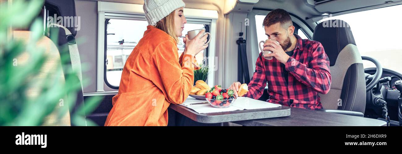 Friends having breakfast in a camper van Stock Photo - Alamy